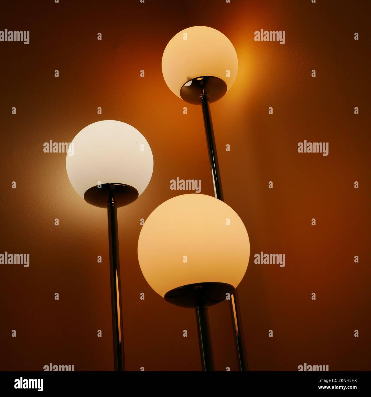 The modern lit lamps on the background of the brown wall Stock Photo ...