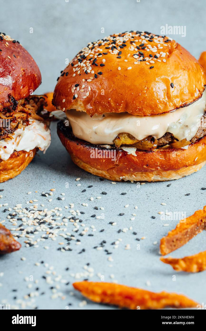 A vertical shot of the classic burgers on a bright background with ...