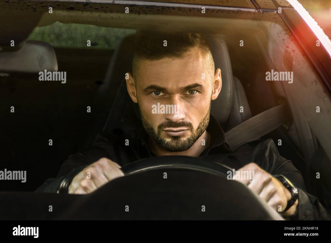 a white man in a suit behind the wheel of a car. stare Stock Photo - Alamy