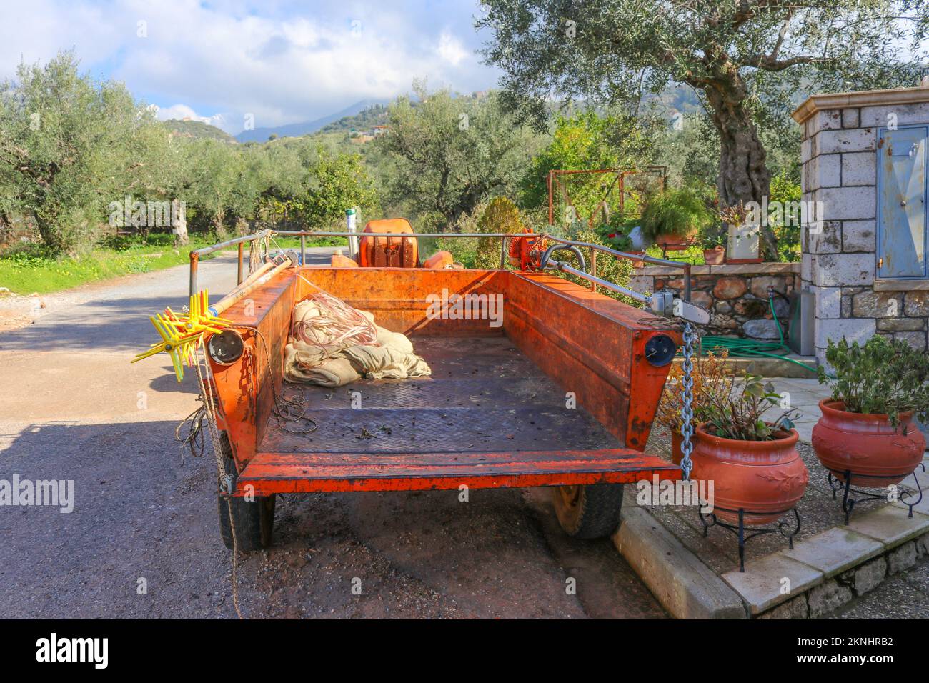 Tractor and trailer with olive rake and pruner parked in Greek village ...