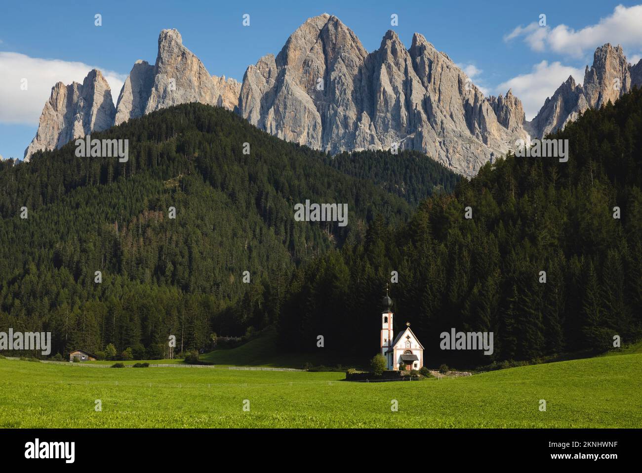 A scenic view of a small church located in an open field with beautiful ...