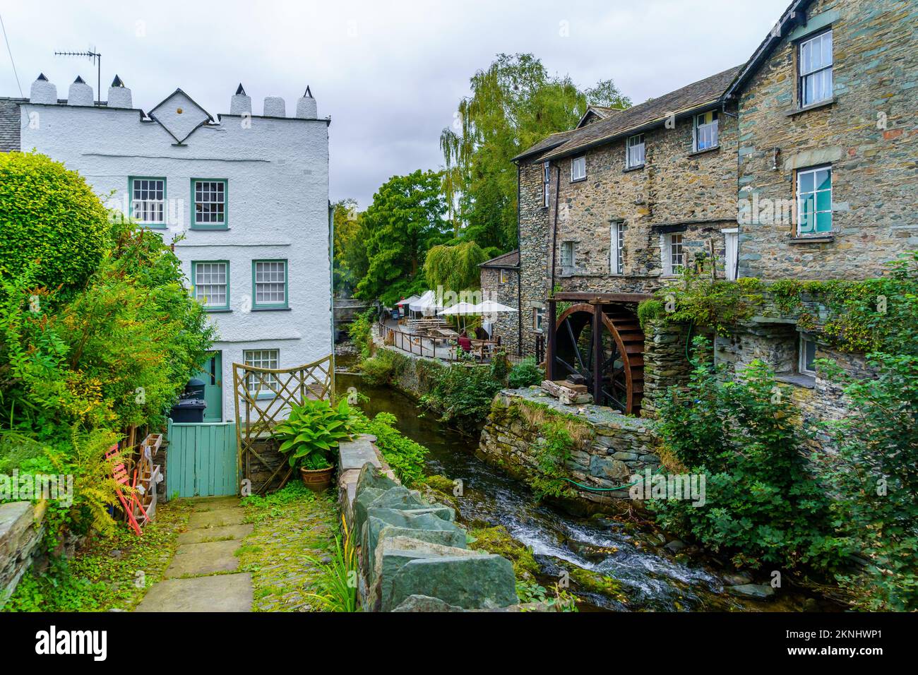 Ambleside, UK - September 25, 2022: View of old houses and a watermill ...