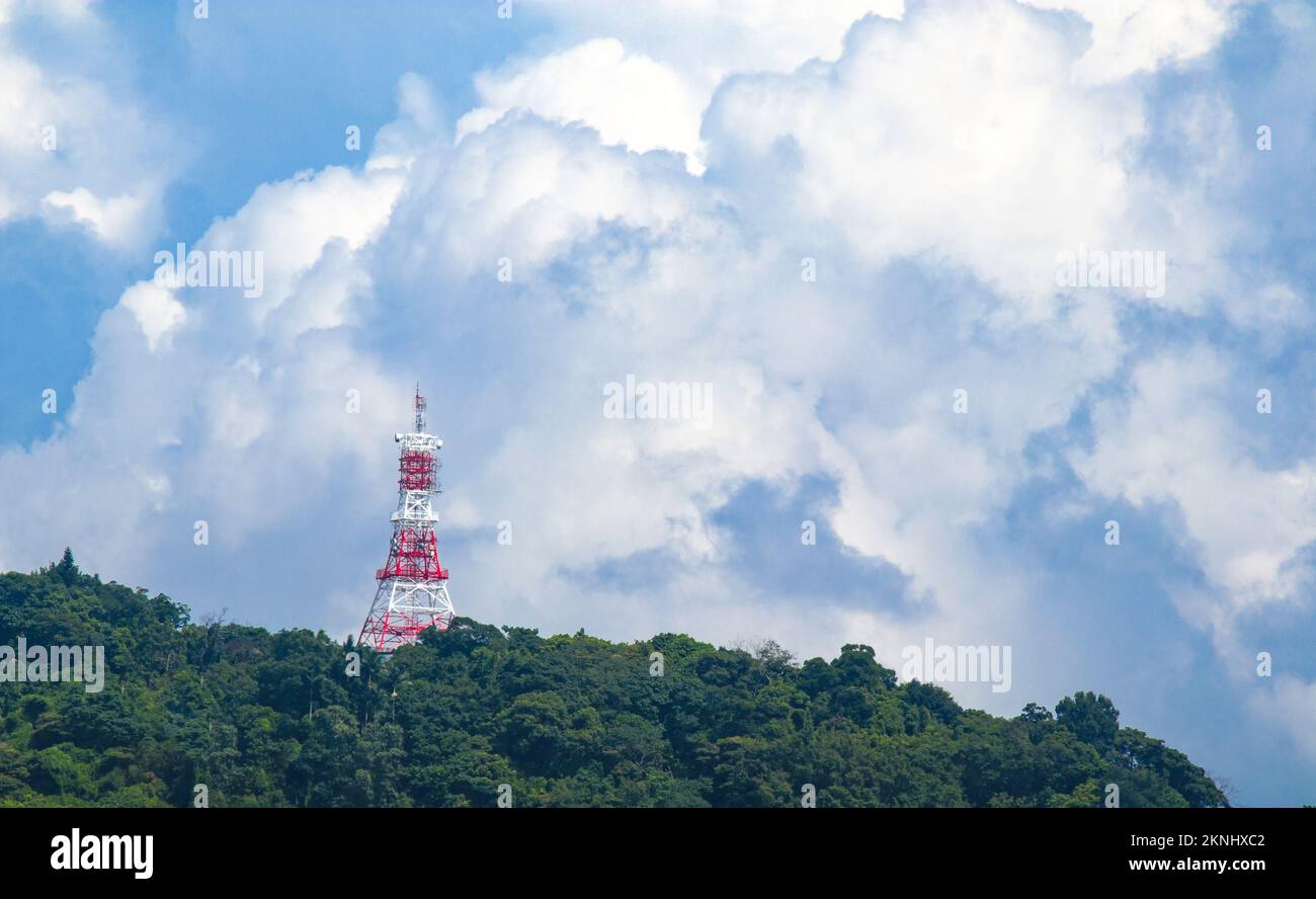A scenic view of a red and white radio tower found on the peak of a ...