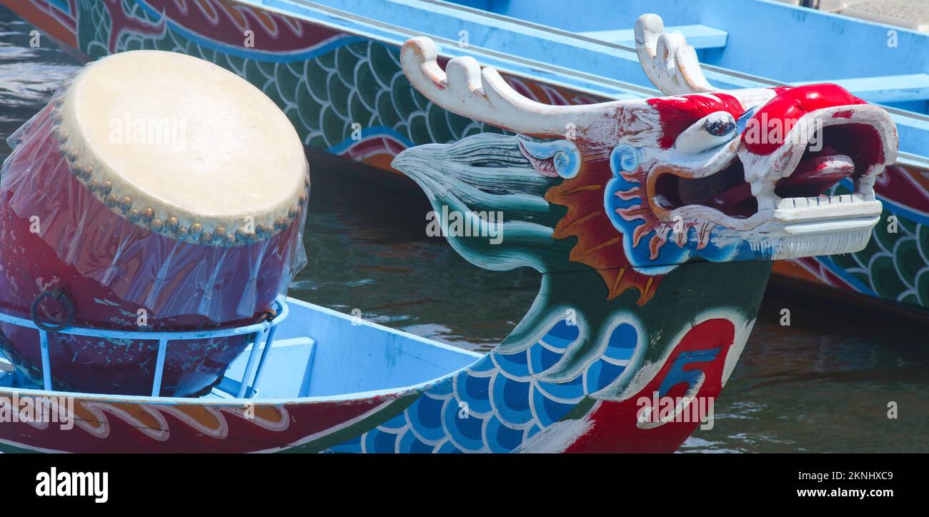 A scenic view of a wooden dragon boat found anchored by the shore of a ...