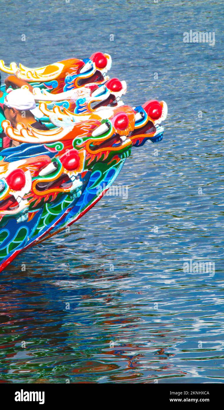 A vertical shot of a colorful wooden dragon boat found anchored at the ...