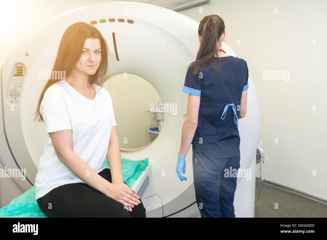 beautiful woman lying on ct scanner bed during tomography test in ...