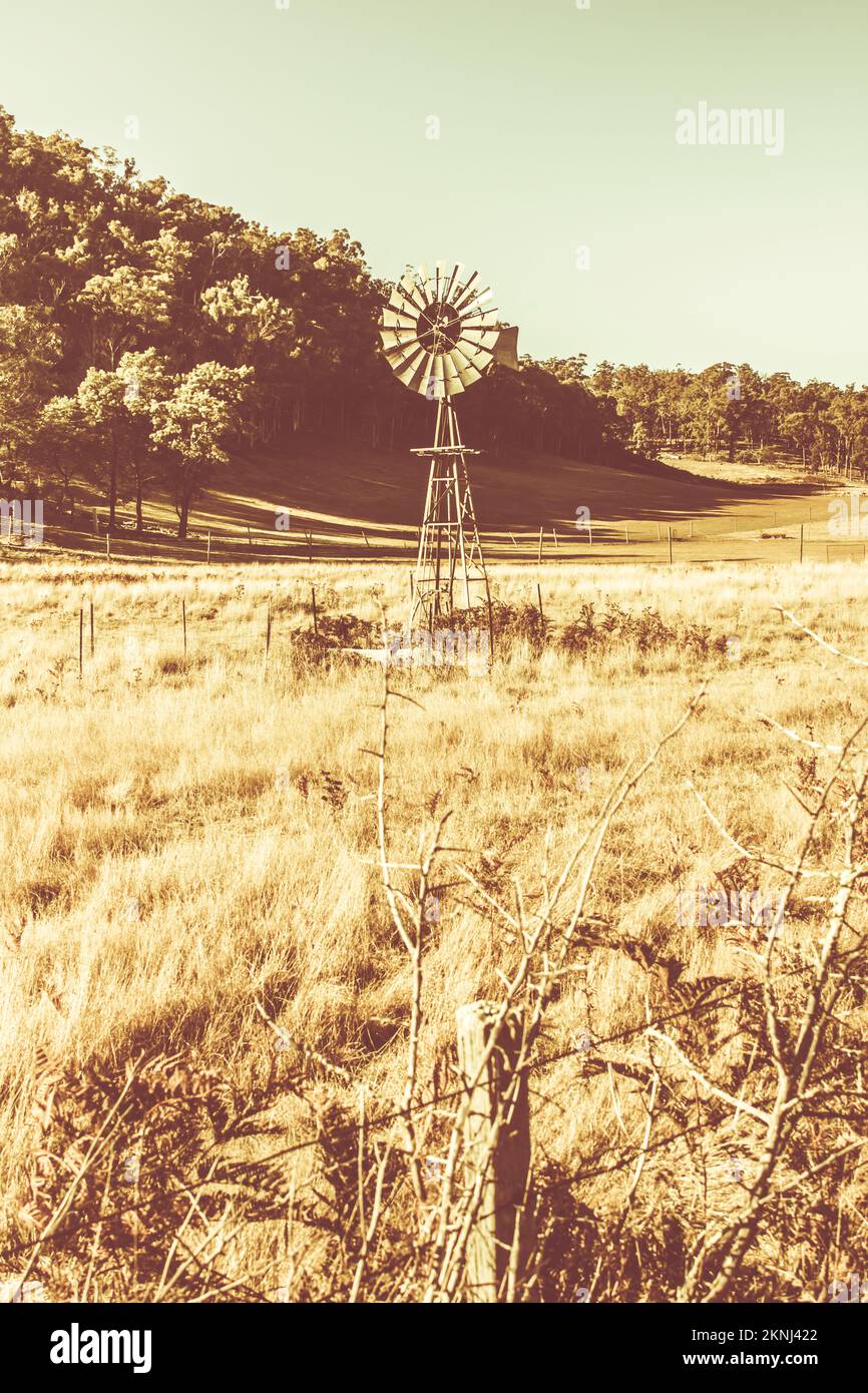 Rural farm ranch landscape with rustic windmill taken in vintage ...