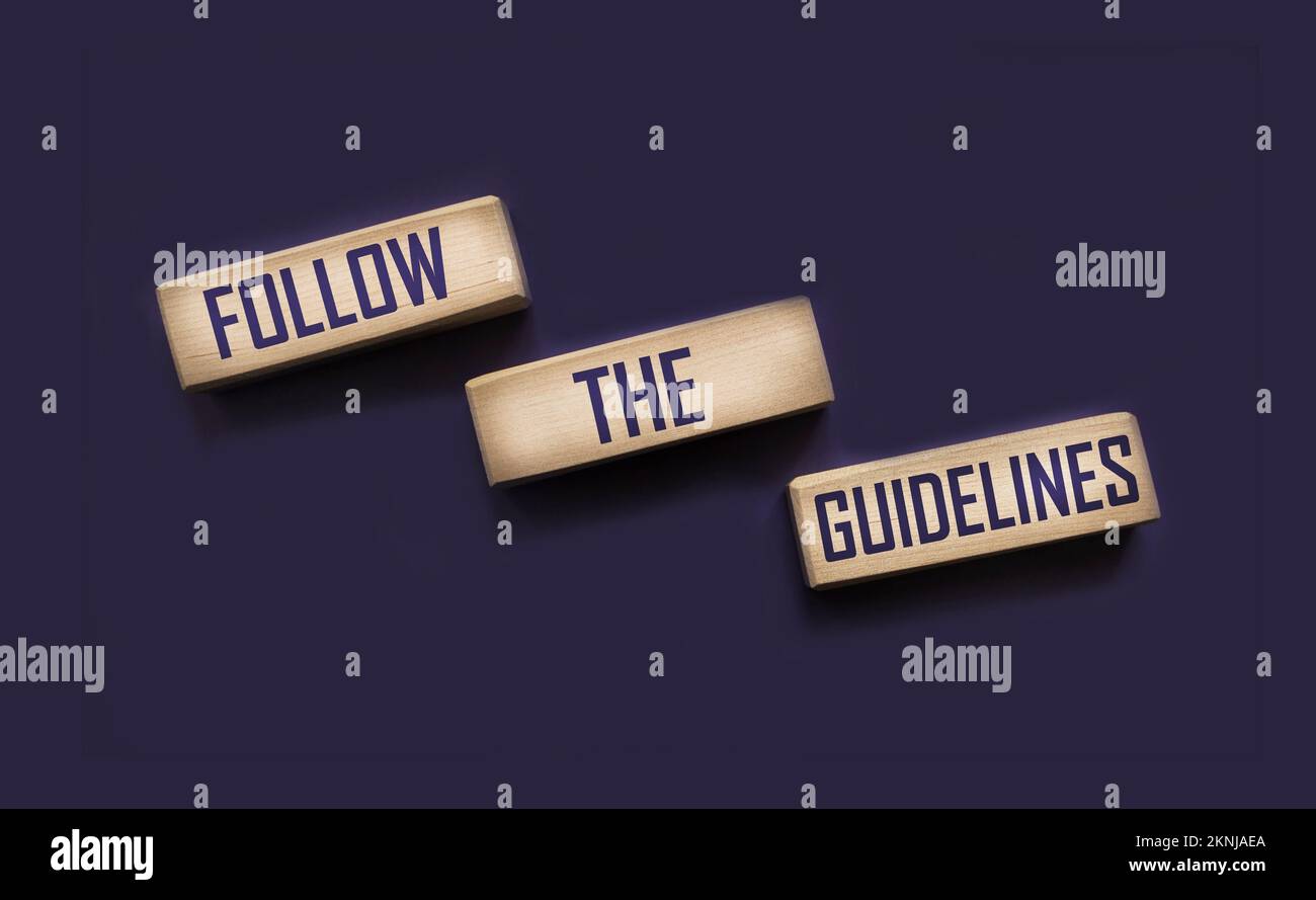 Wooden blocks with text FOLLOW THE RECOMMENDATIONS on purple background ...