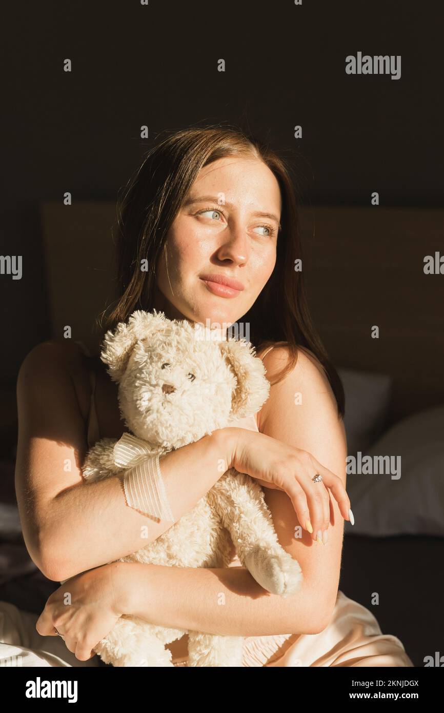 Portrait Of Girl Is Waking Up In Morning Stretches In Bed And Sun