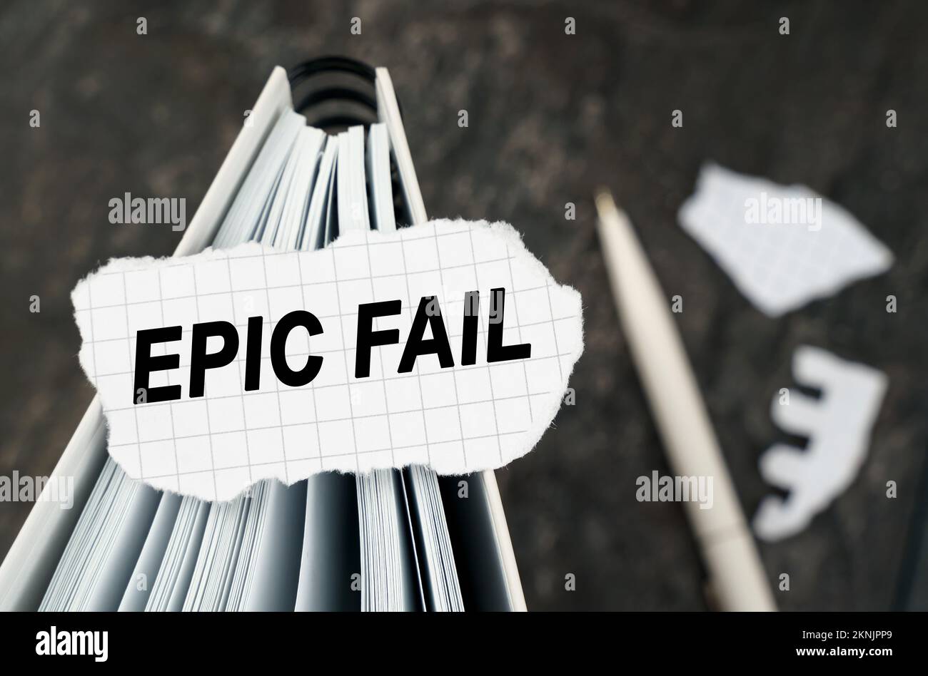 On the table is a notebook on which lies a piece of torn paper with the ...