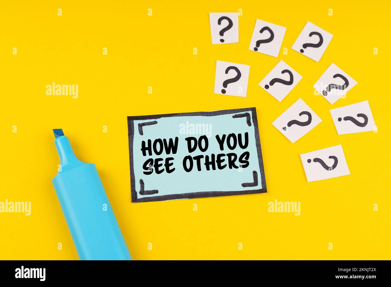 Business concept. On the yellow surface lies a blue marker, question ...