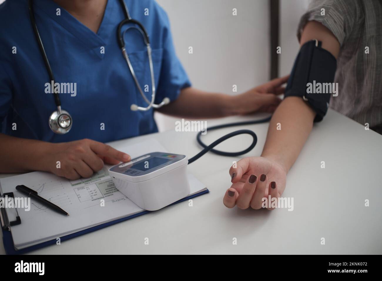 Nurse measuring blood pressure of a patient Stock Photo - Alamy