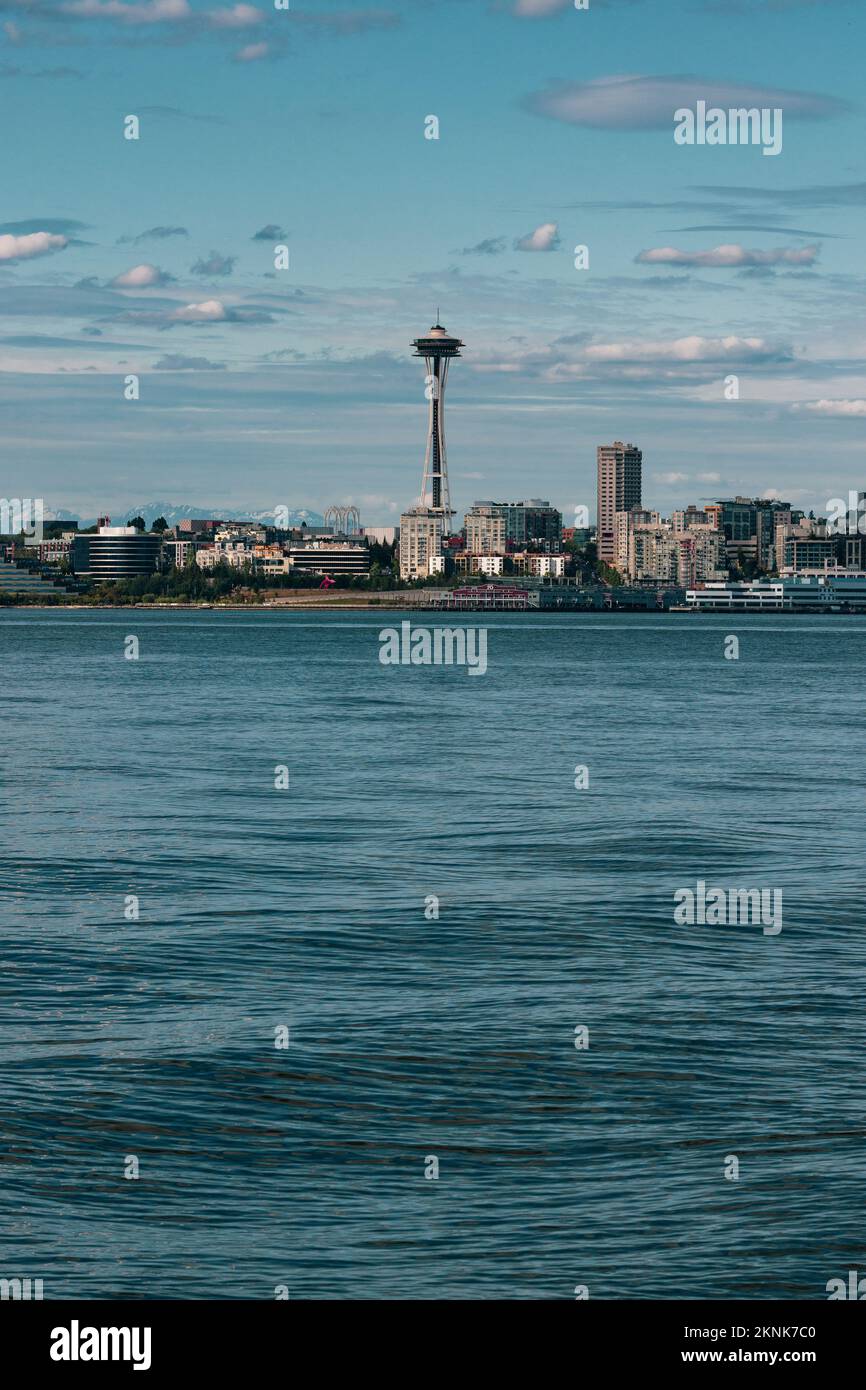 A vertical shot of a beautiful Seattle Space Needle from Alki beach and ...