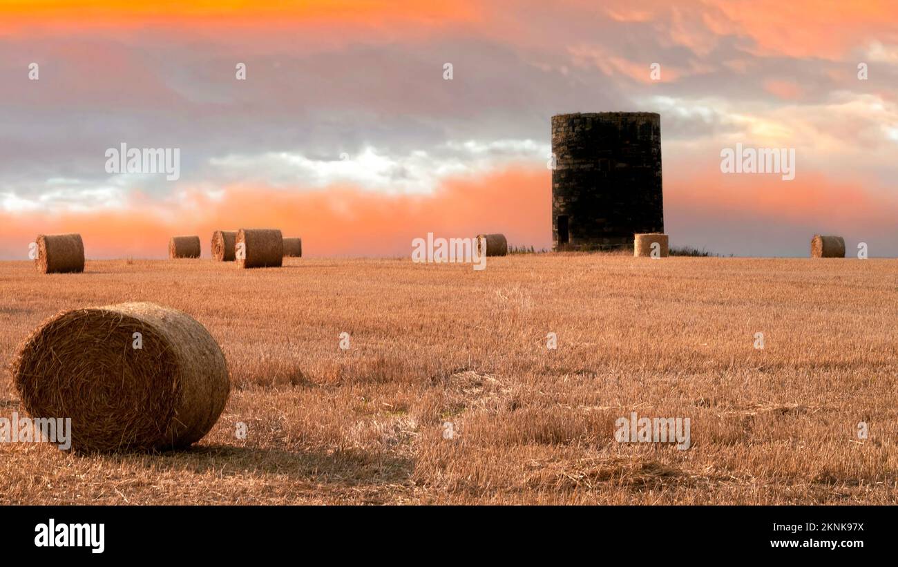 The cloudy sky over the field with haystacks at sunset Stock Photo - Alamy