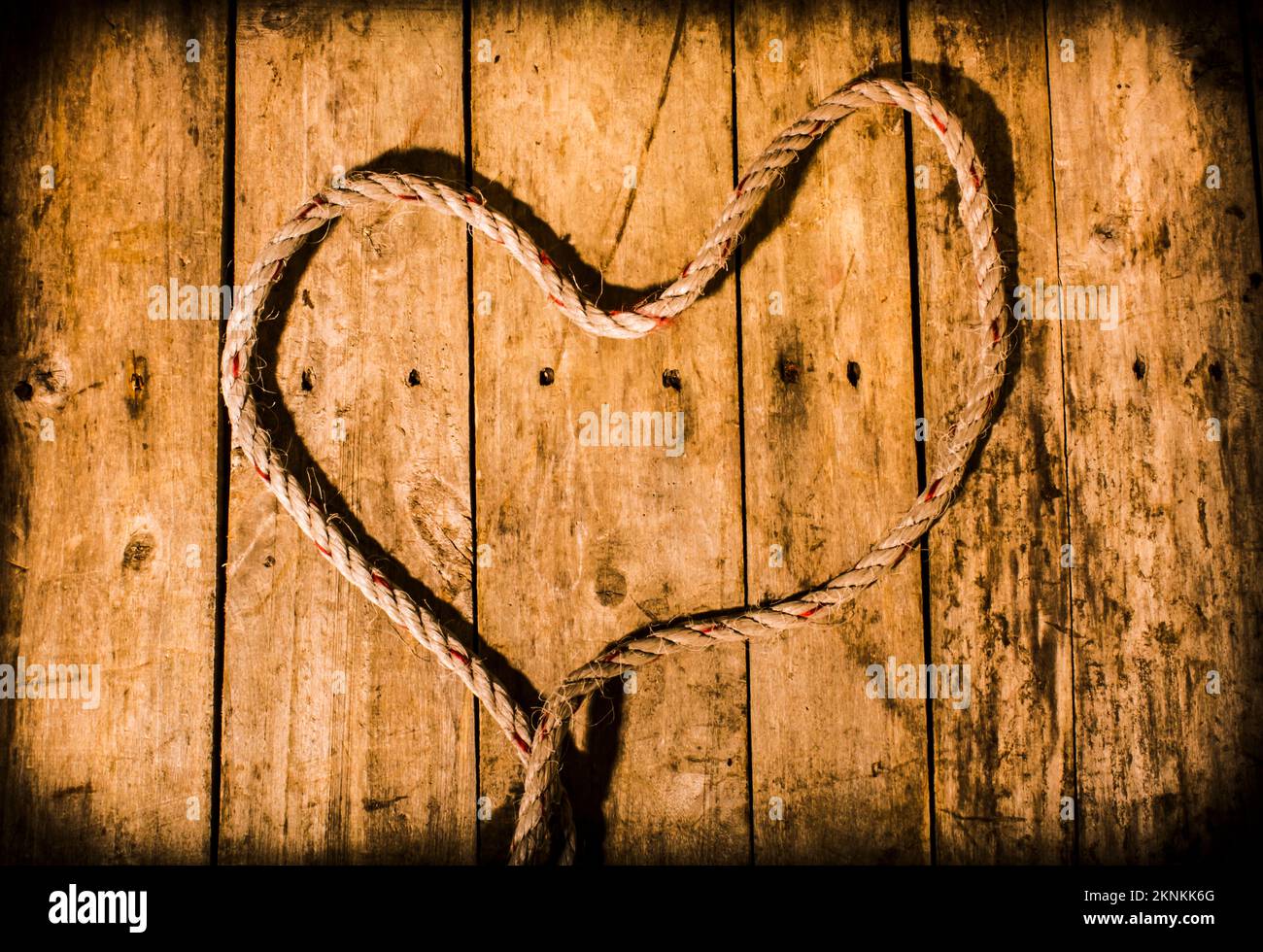 Wooden marine decor in the form of a ship shape heart on planked ...