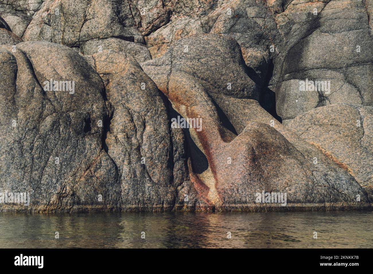 A scenic view of a huge coastline rock with reflective water Stock ...