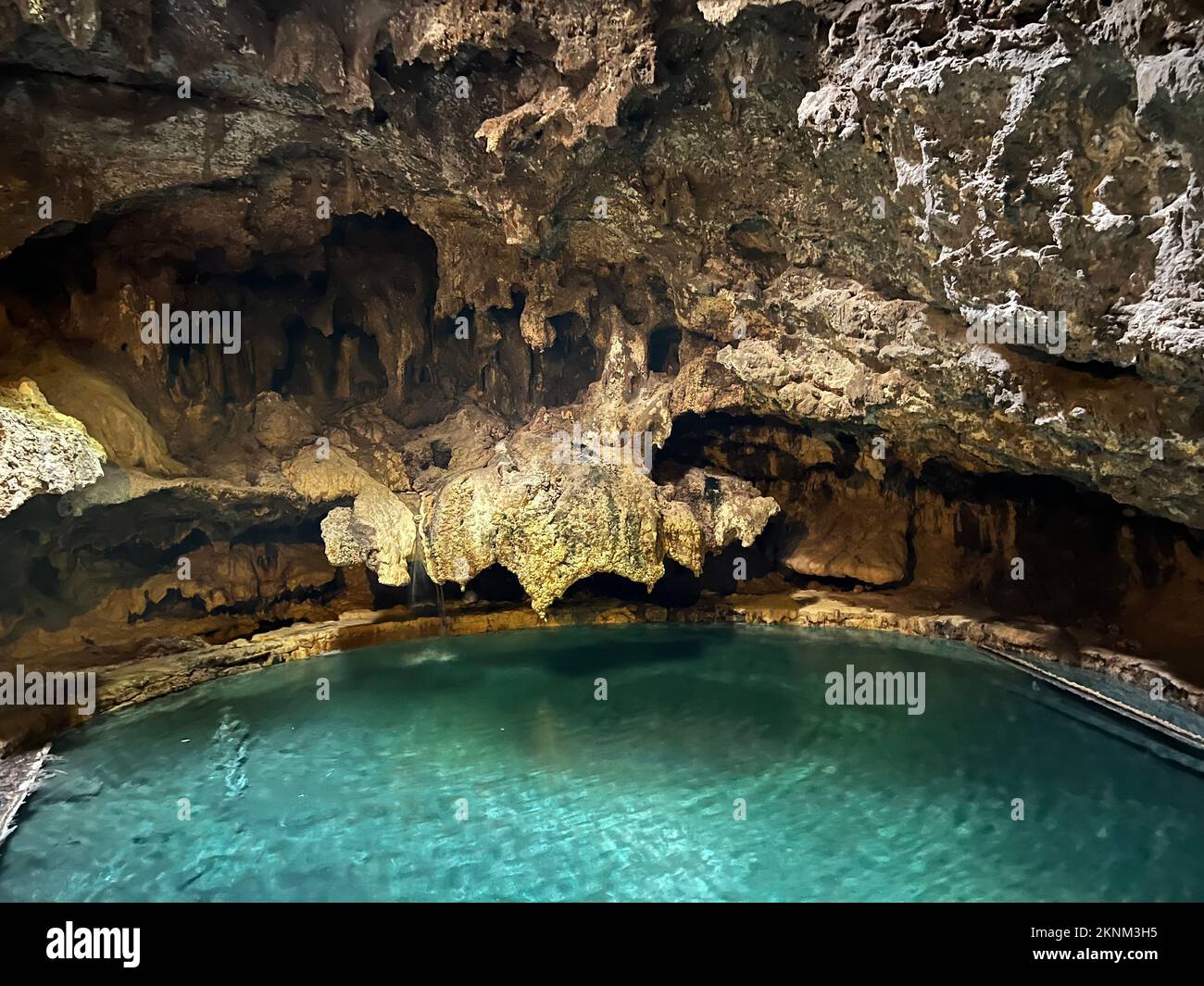 A scenic turquoise hot spring inside a rugged cave Stock Photo - Alamy