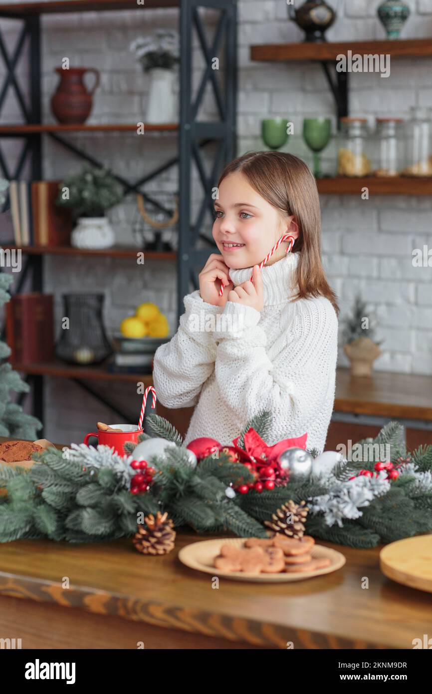 Cute smiling little child girl eating chocolate biscuits and drinking ...
