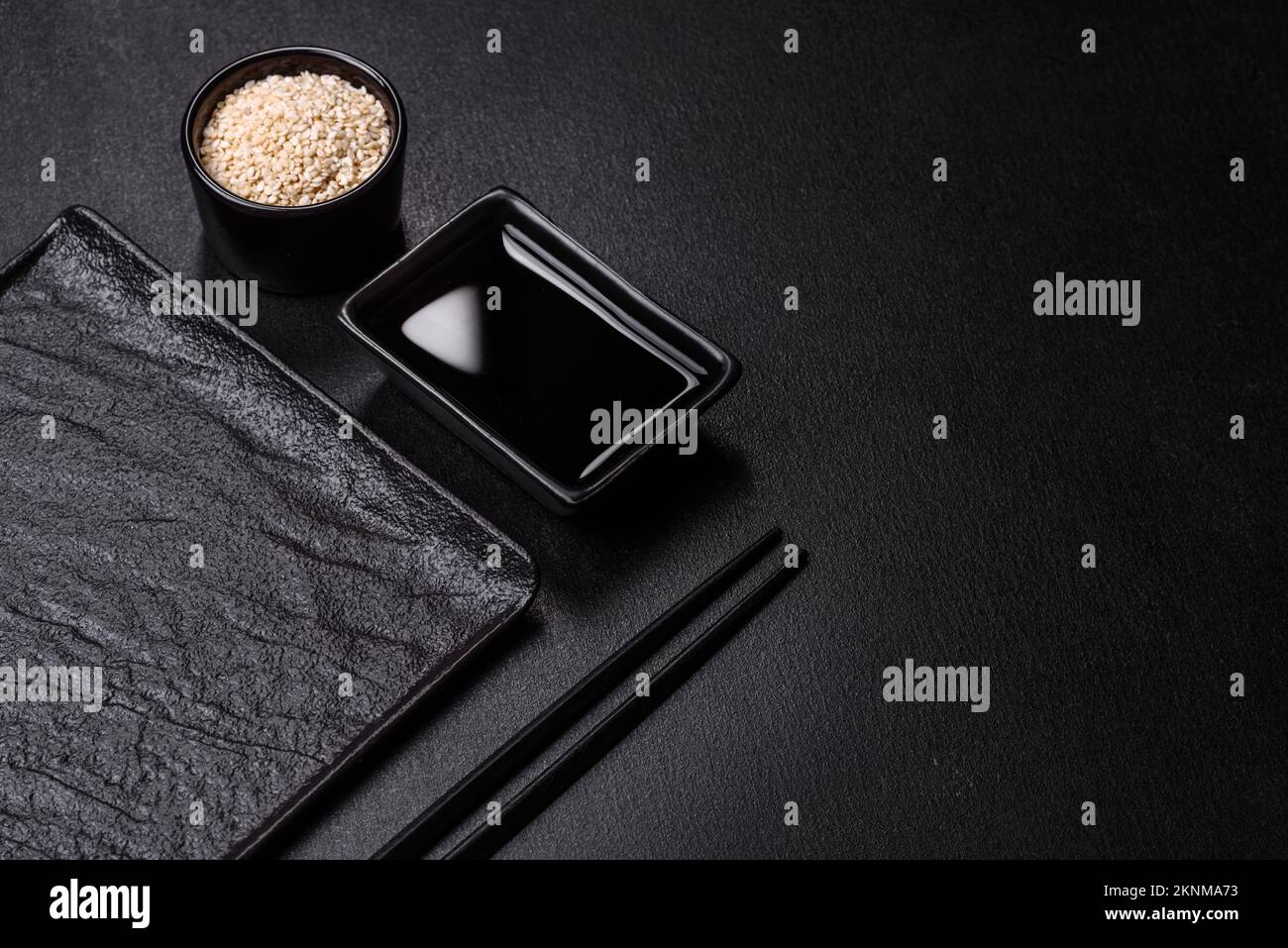 Empty plate with wooden sticks for Asian food on a dark concrete ...