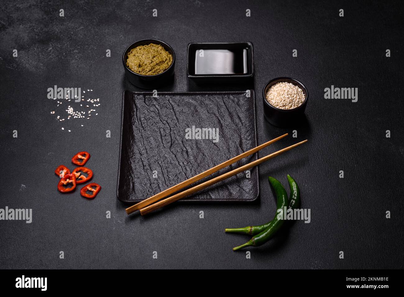 Empty plate with wooden sticks for Asian food on a dark concrete ...
