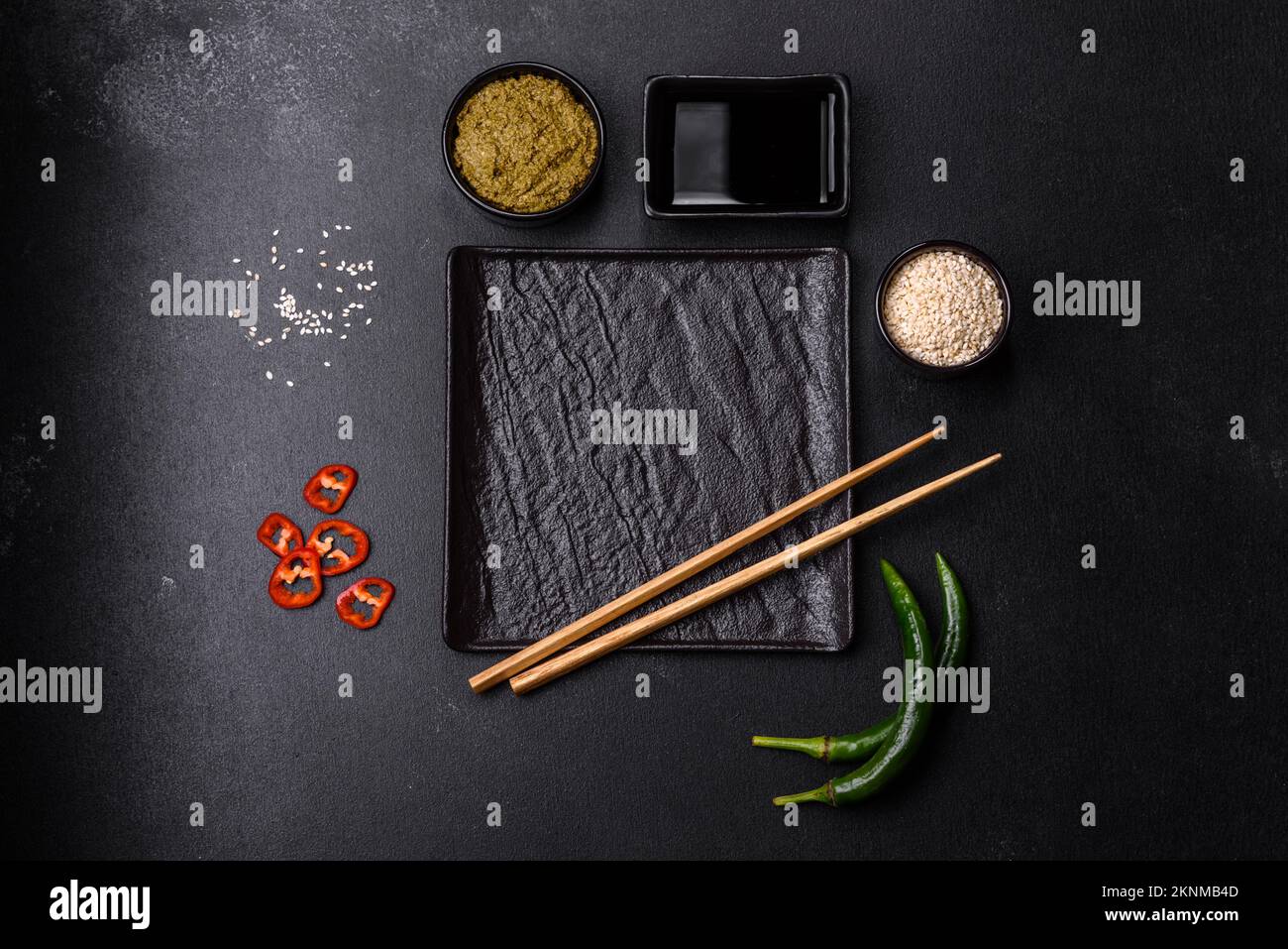 Empty plate with wooden sticks for Asian food on a dark concrete ...
