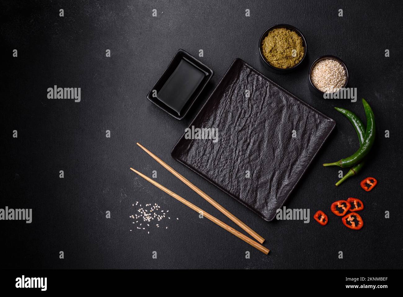 Empty plate with wooden sticks for Asian food on a dark concrete ...