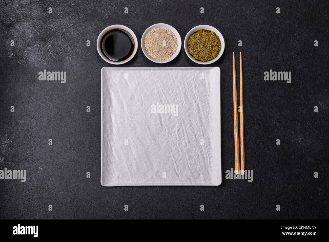 Empty plate with wooden sticks for Asian food on a dark concrete ...