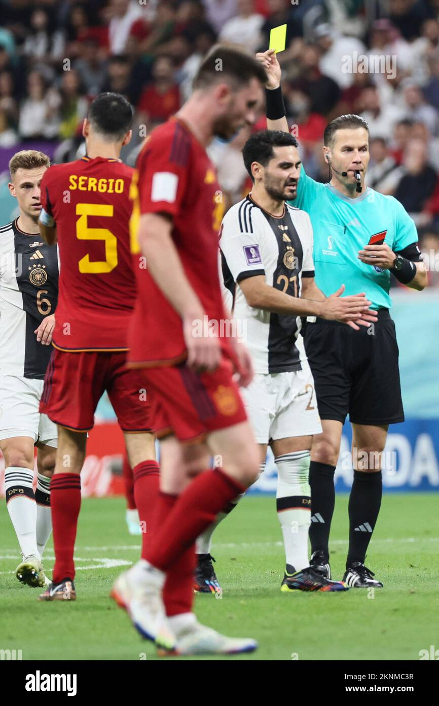 Al Khor, Qatar. 27th Nov, 2022. Referee Danny Makkelie (1st R) shows a yellow card to Spain's ...