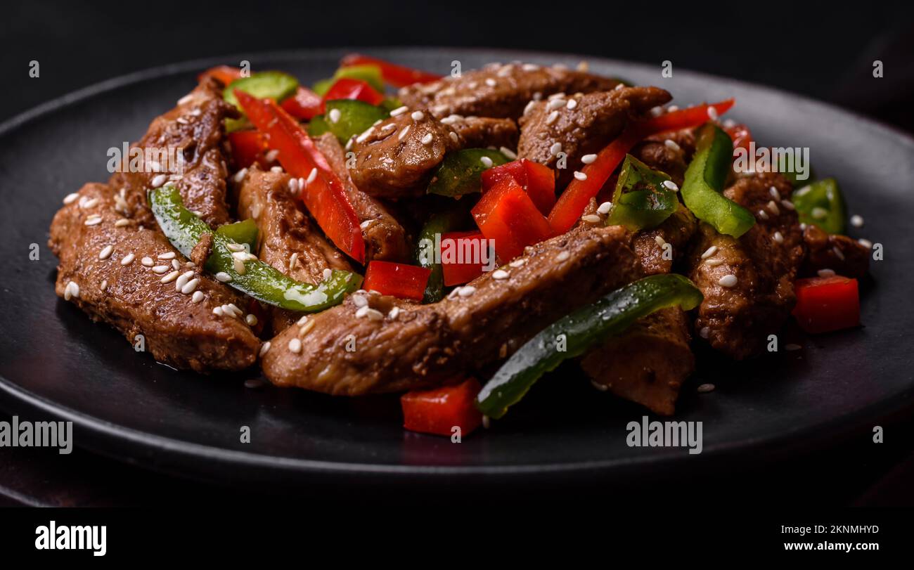 Delicious Asian teriyaki meat with red and green bell peppers and ...
