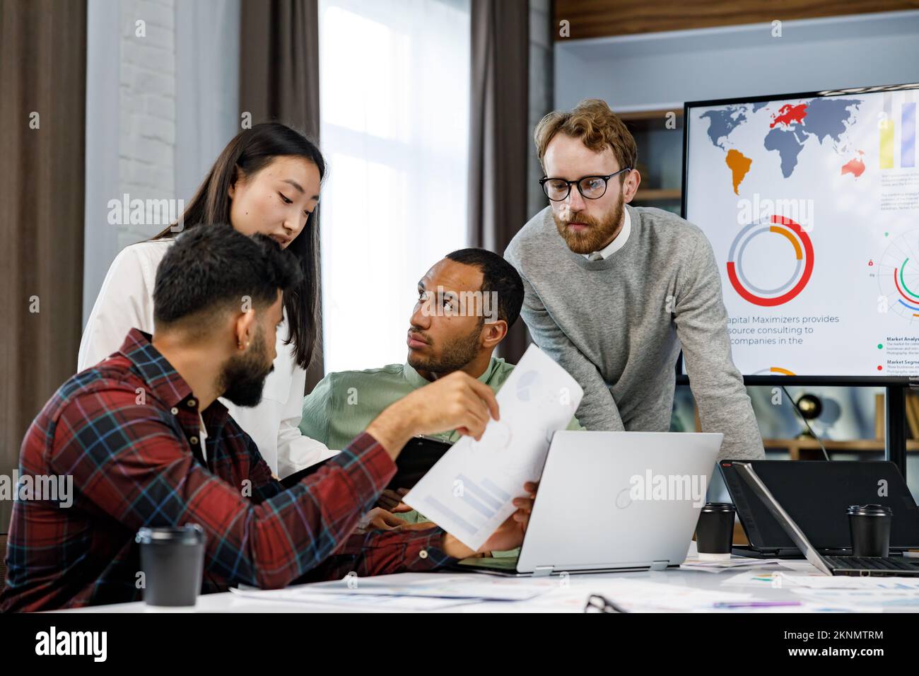 A team of young multinational business people are working on a startup ...