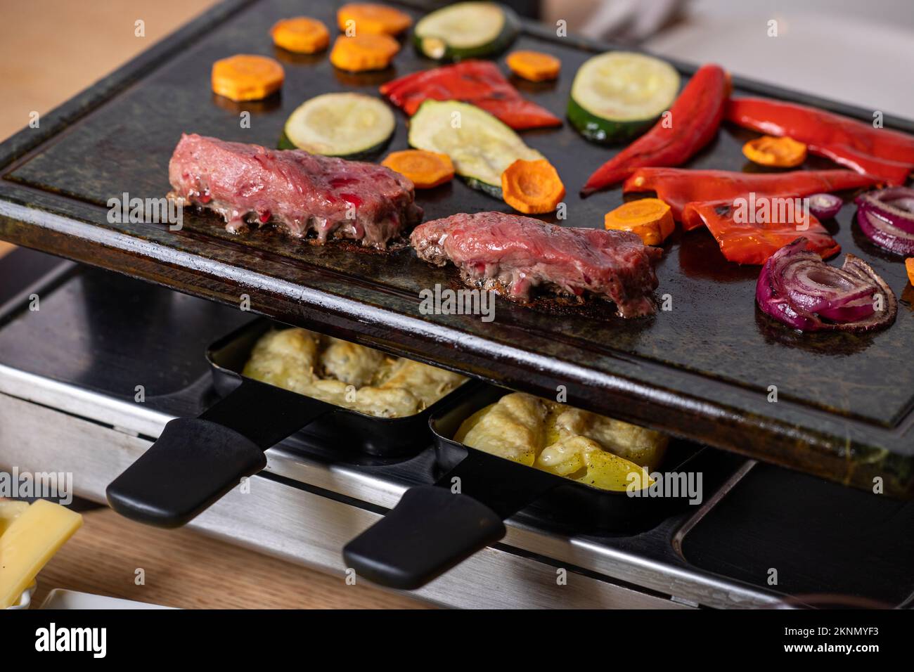 swiss raclette with meat and vegetables Stock Photo - Alamy