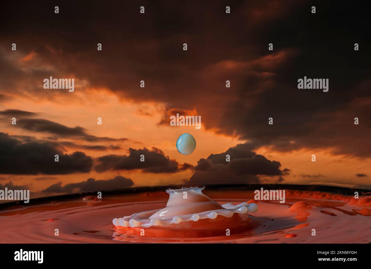 drops of milk colliding formed figures with the background of a sunrise ...