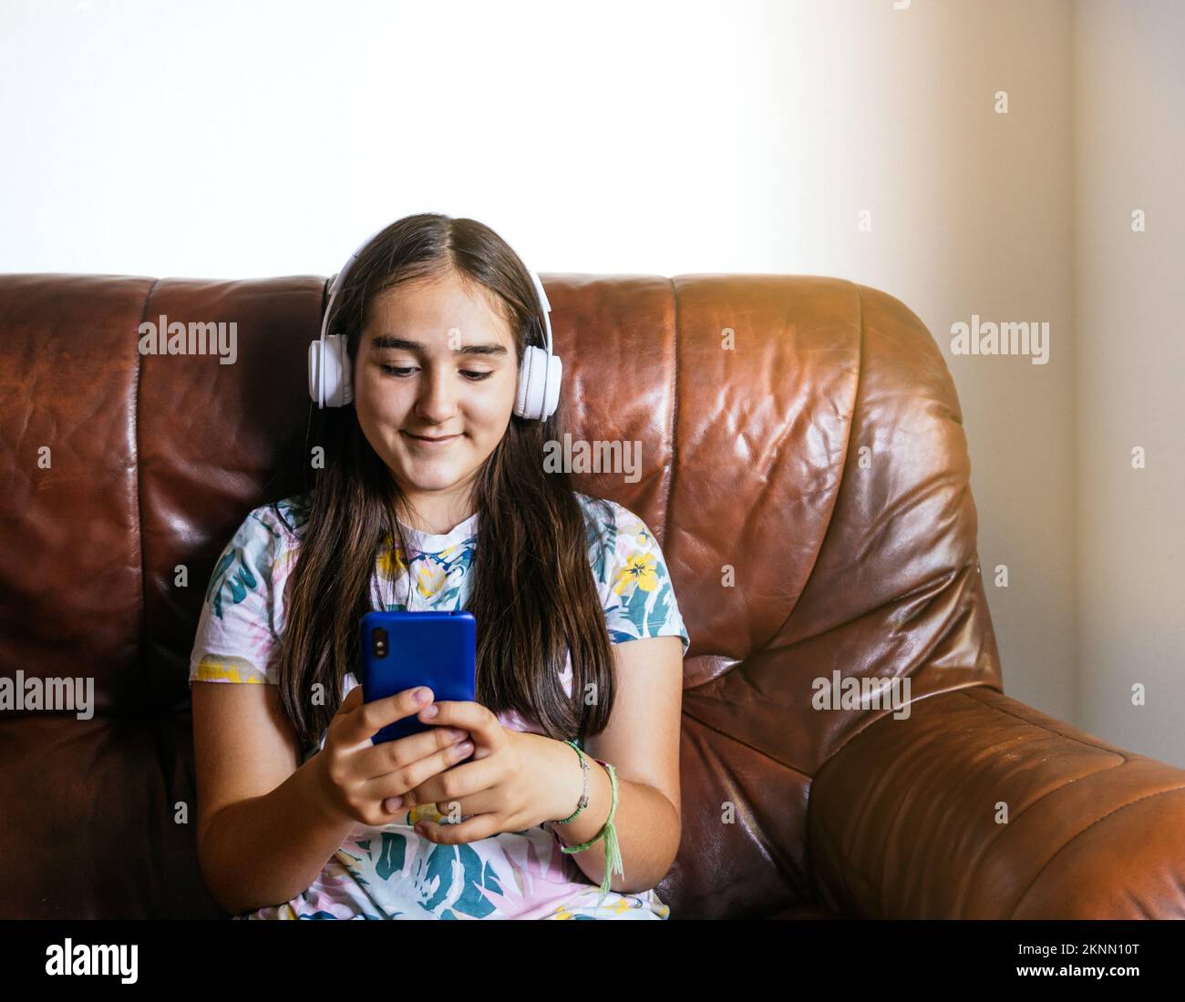 A scenic view of a Hispanic girl wearing a white headset while talking ...