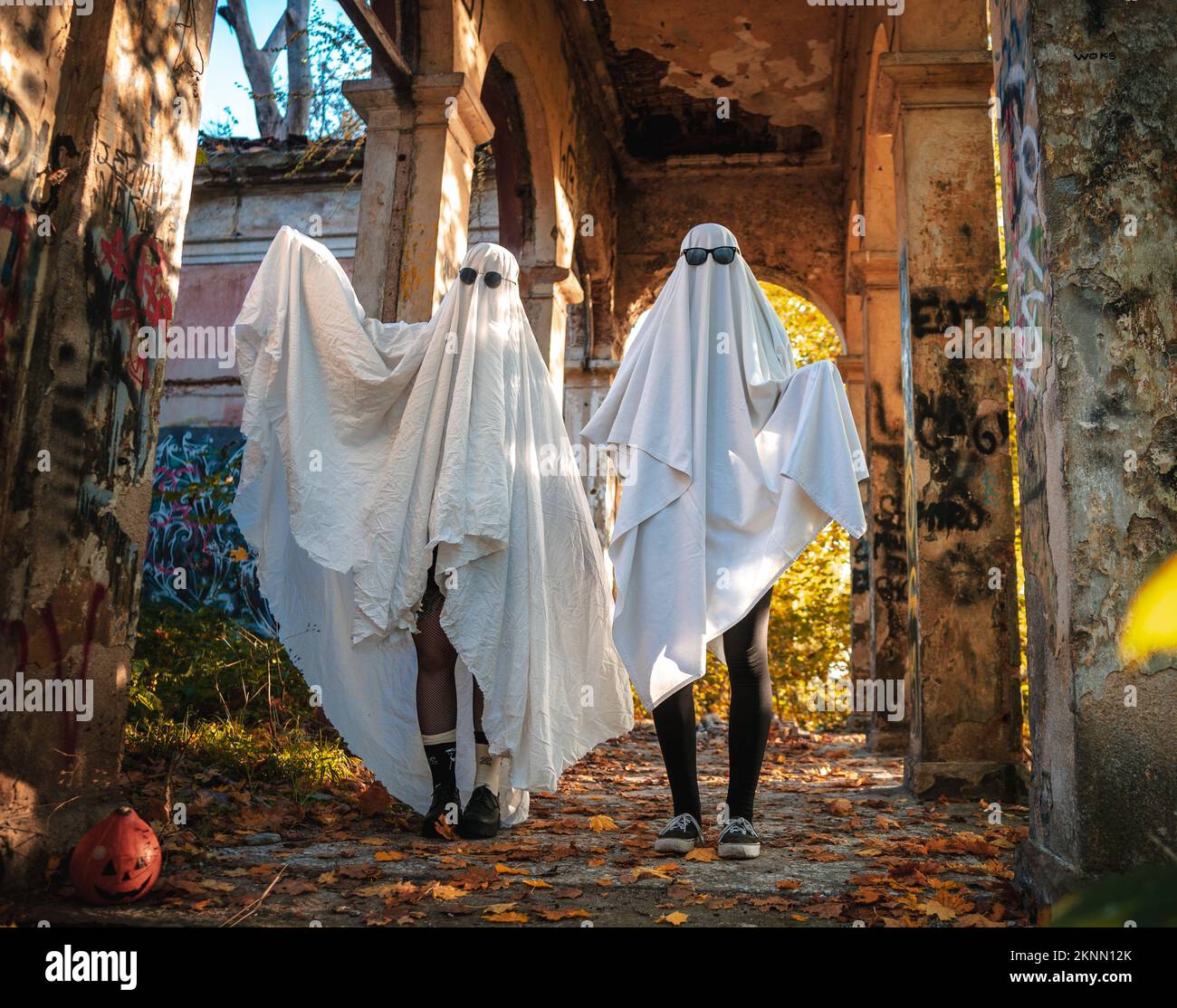 A funny image of two people in ghost costumes and sunglasses in an ...