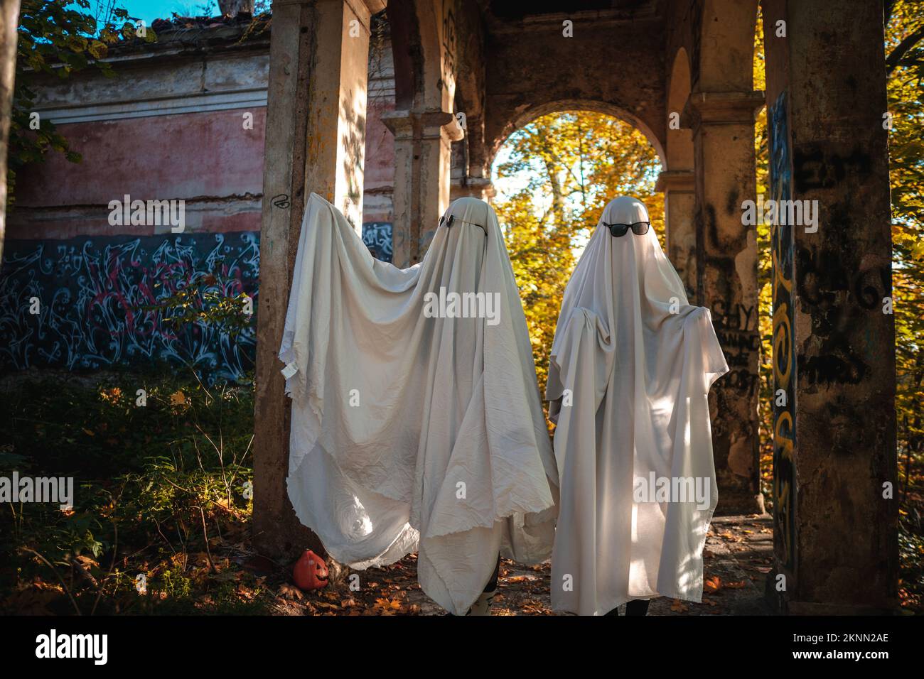 A funny image of two people in ghost costumes and sunglasses in an ...