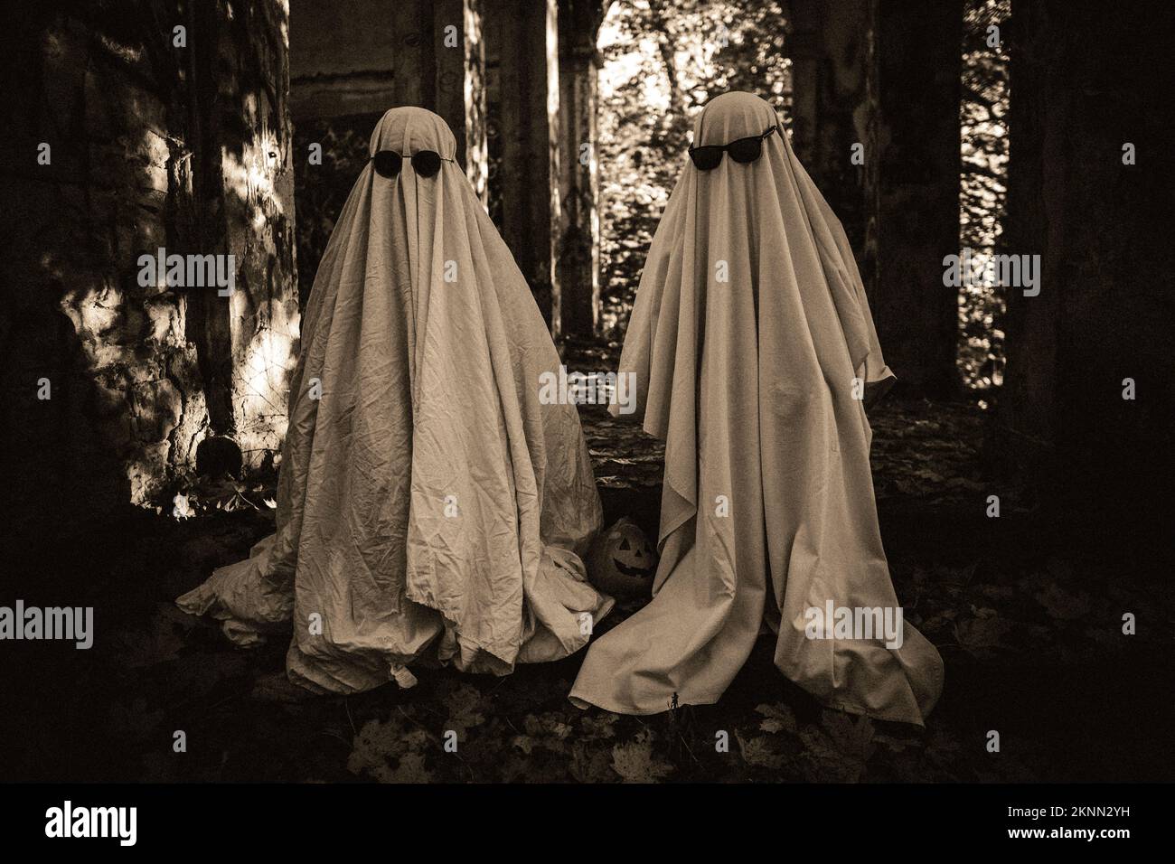 A funny image of two people in ghost costumes and sunglasses in an ...