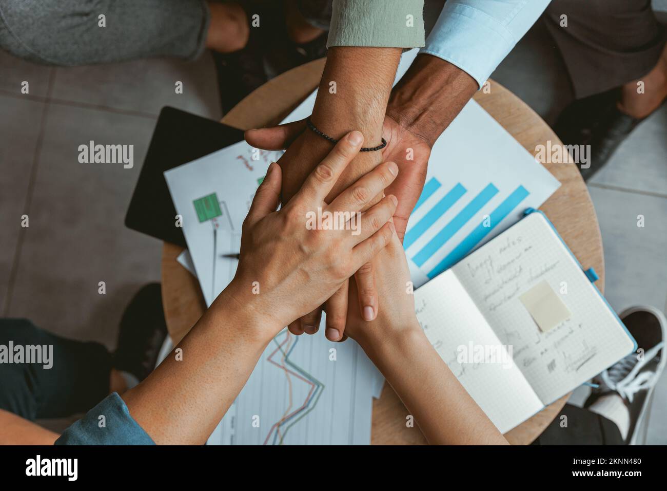 Top view of group multi ethnic coworkers stacked hands together as ...