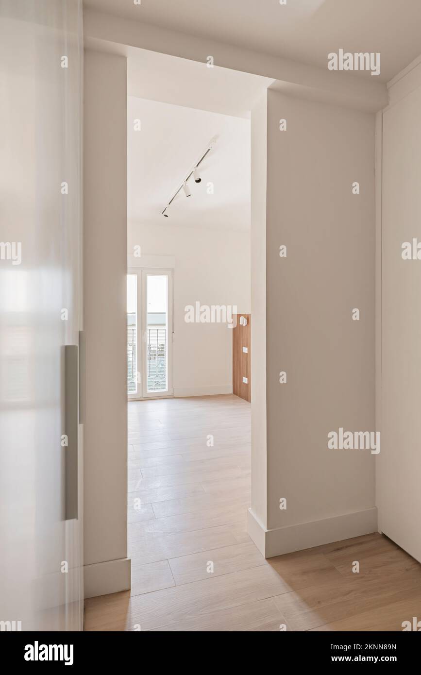Bedroom with a dressing room with smooth wooden doors and an empty room ...