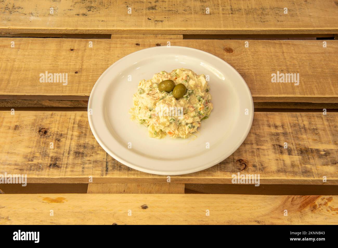Plate of ensaladilla rusa typical to serve in a tapas bar on a surface ...
