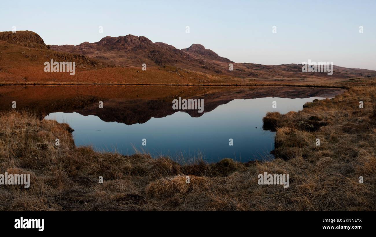 Green Crag reflected in Low Birker Tarn, in the English Lake District ...