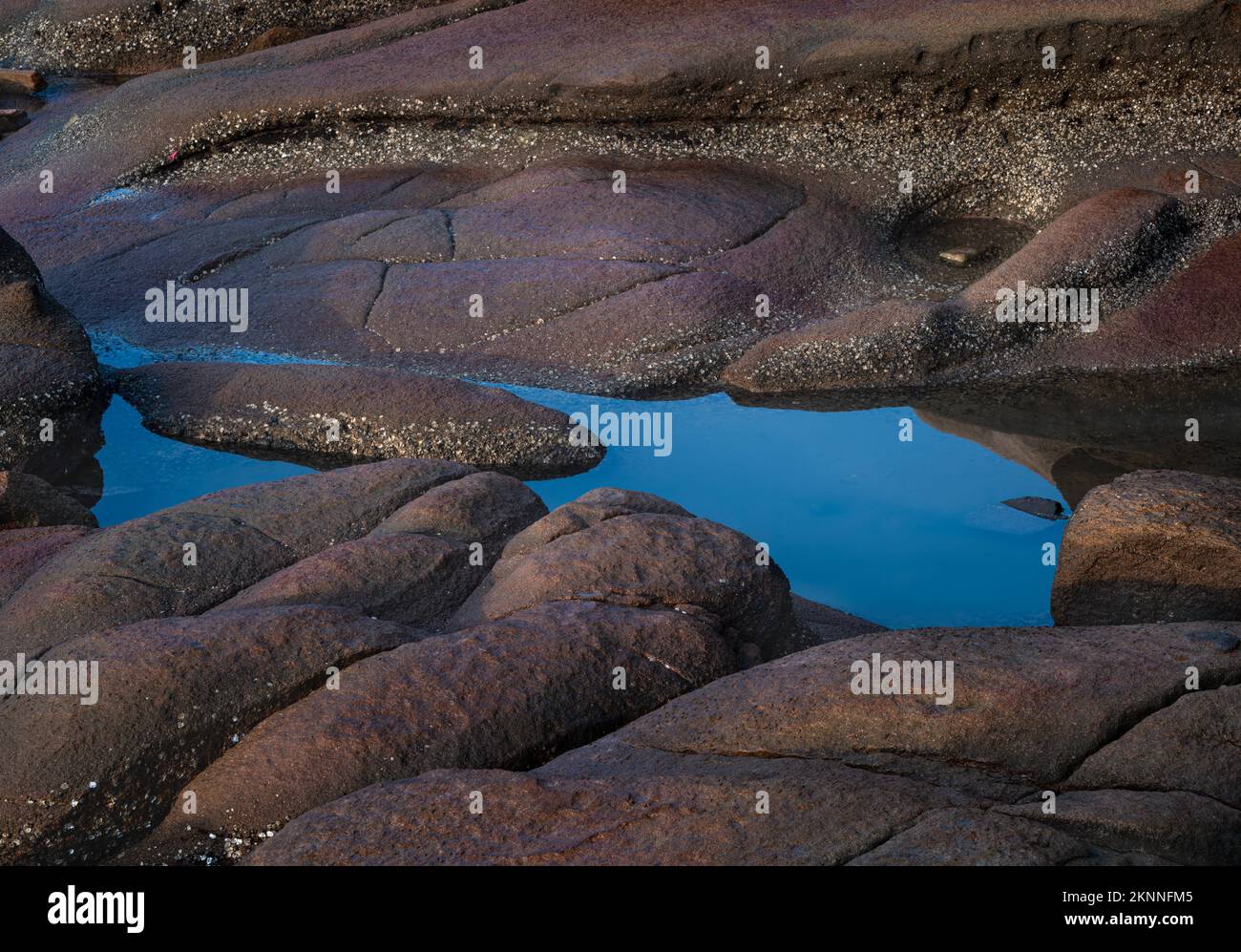 A scenci view of a small body of water surrounded by rocks Stock Photo ...