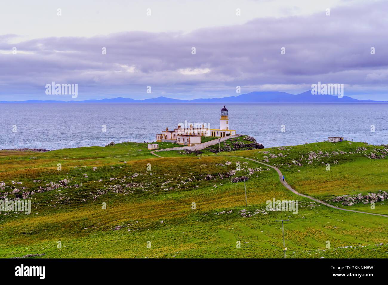 Sunset view of Neist Point Lighthouse, coastal cliffs, and rocks, in ...