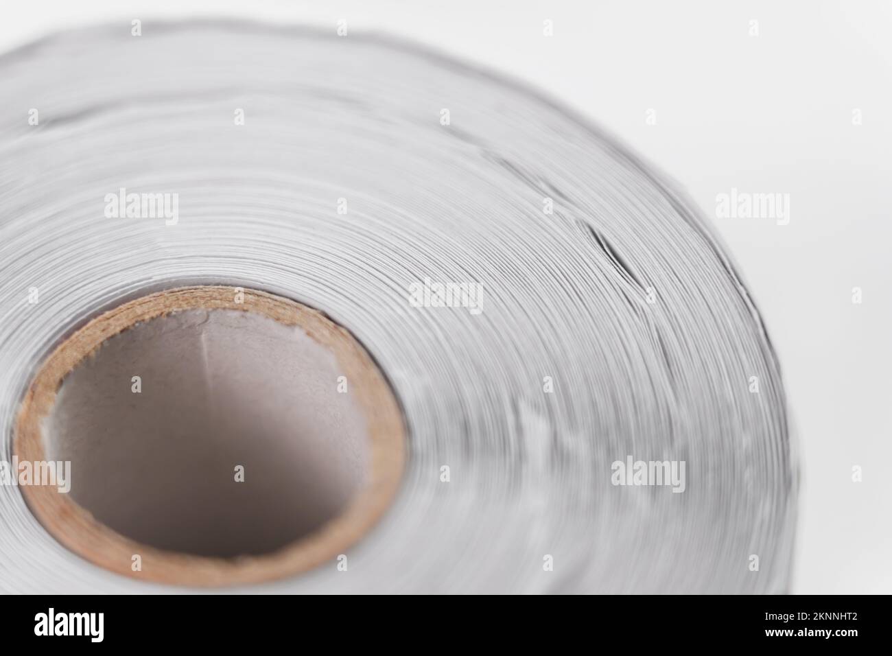 Rolled up roll of recycled white paper. Macro. Rotation Stock Photo - Alamy