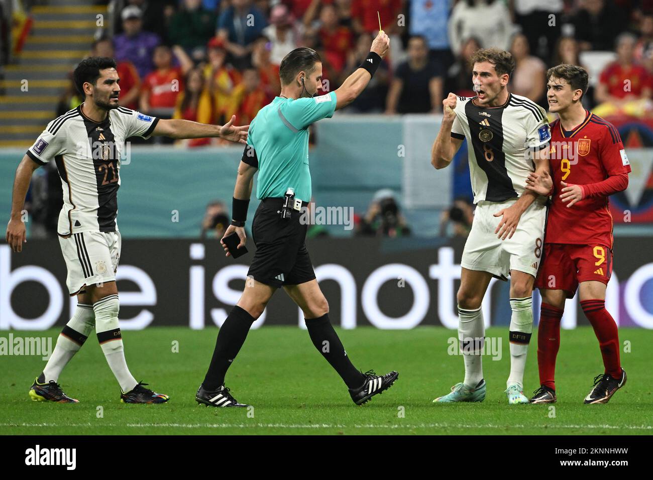 Al Khor, Qatar. 27th Nov, 2022. Referee Danny Makkelie (2nd L) shows a yellow card to Germany's ...
