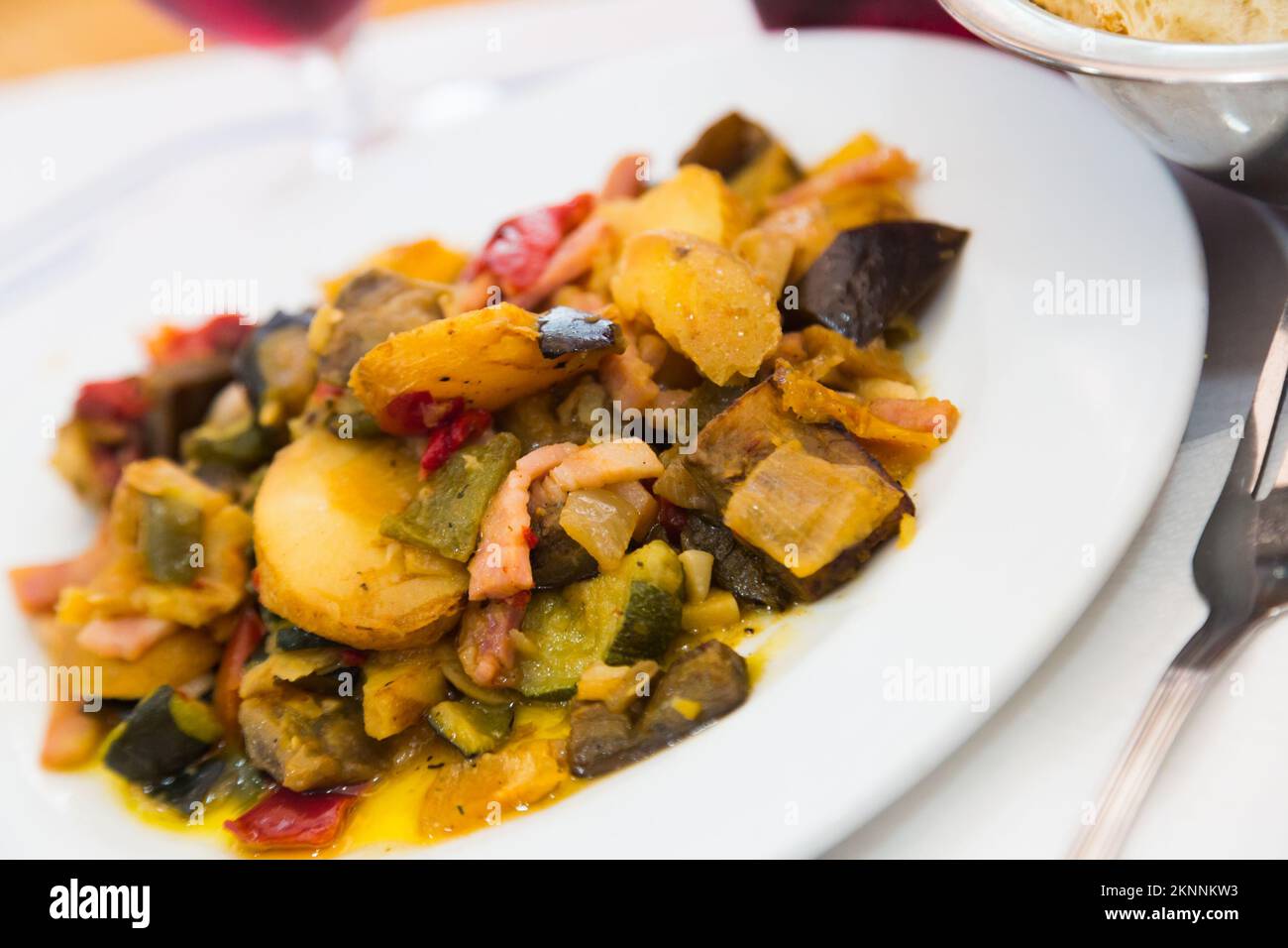 Dish of tasty fried different vegetables with bacon at white plate ...