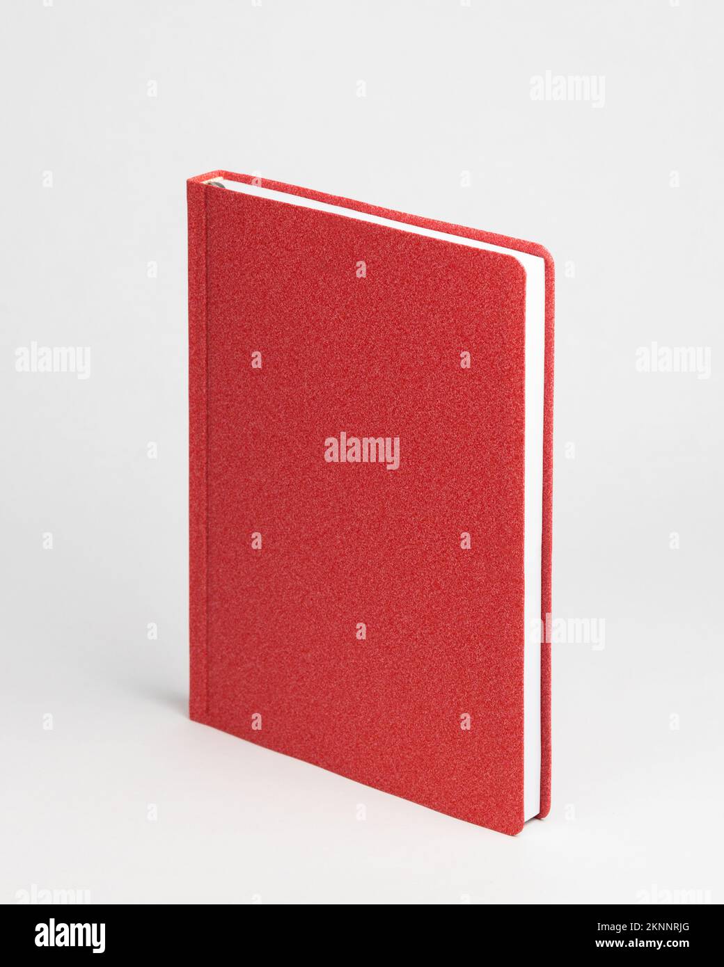 Red blank diary in standing view on table on white background Stock ...