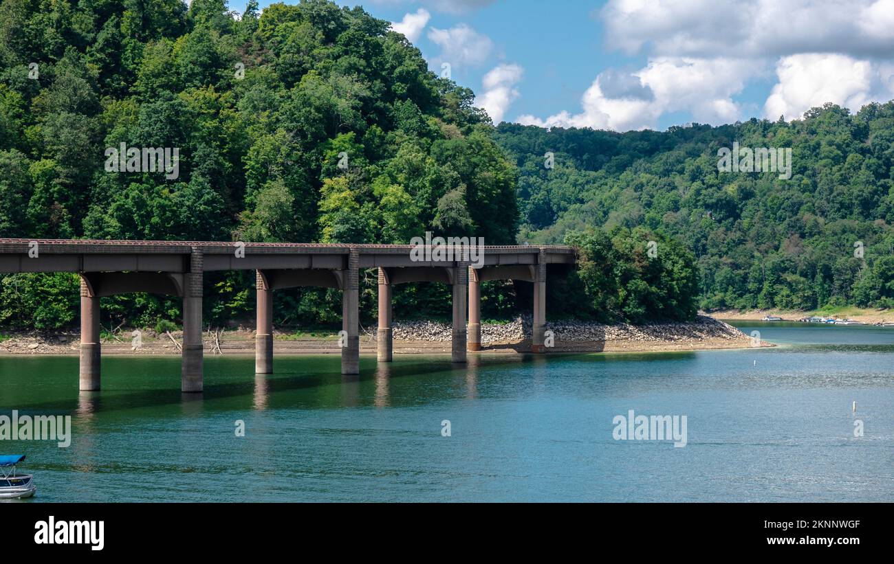 A scenic view of Youghiogheny River Lake with a bridge surrounded by ...