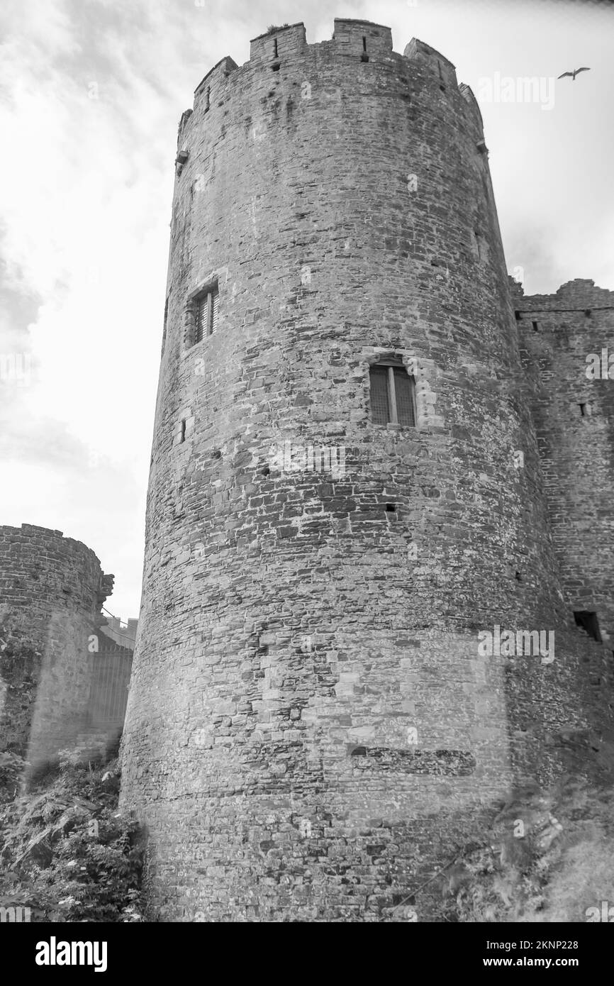 A vertical grayscale of the historic Conwy Castle in Wales with a ...