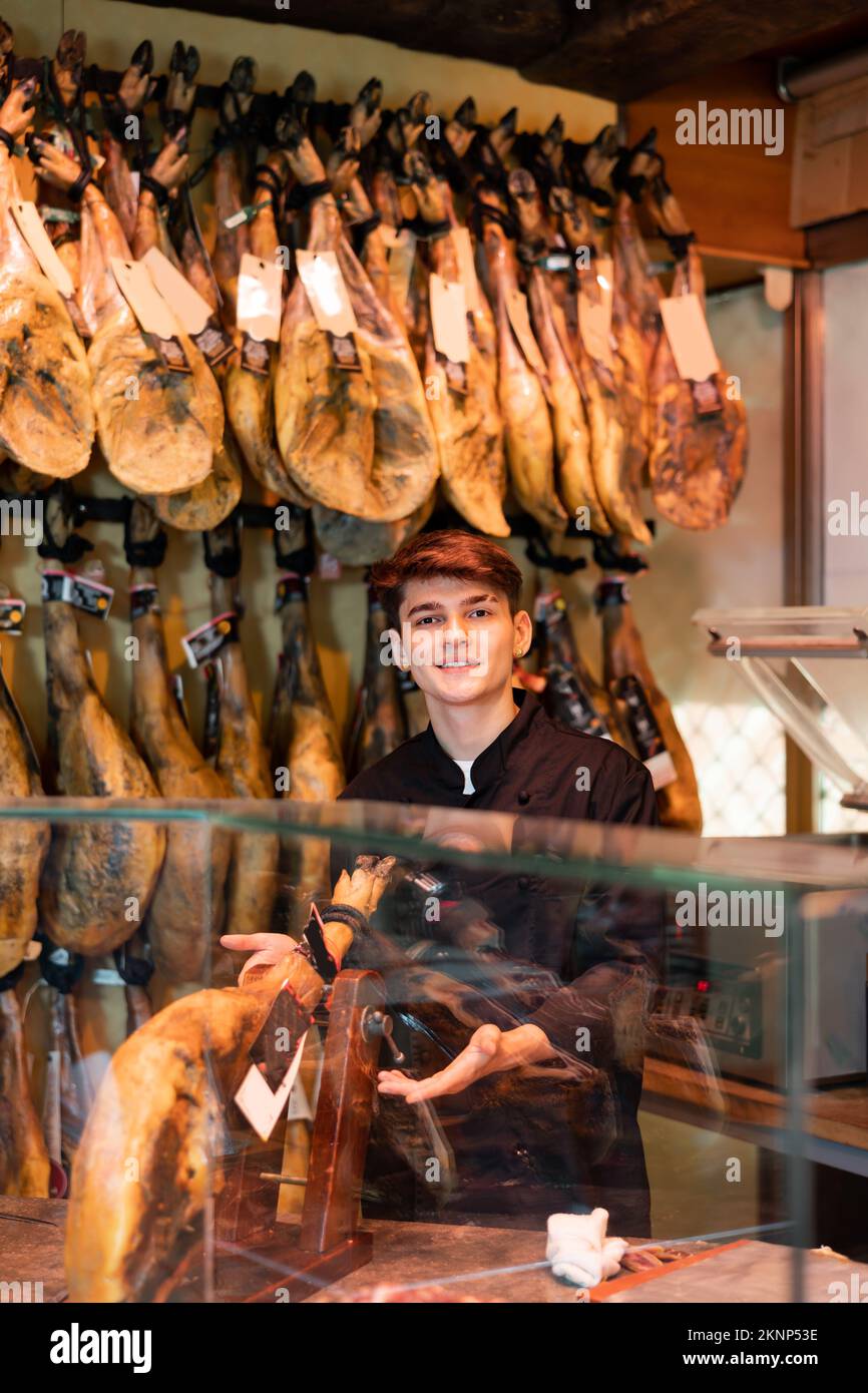 Owner of butcher shop selling traditional spanish jamon Stock Photo - Alamy