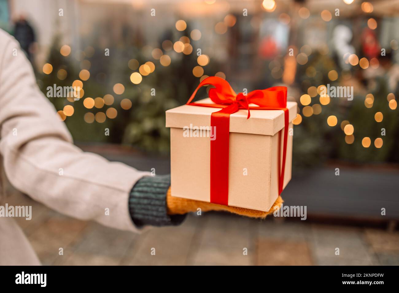 Closeup of hands give surprise gift box, gift brown package box with ...